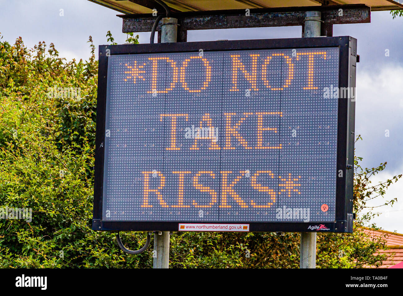 Road sign warning drivers to check the tide and safe crossing times ...