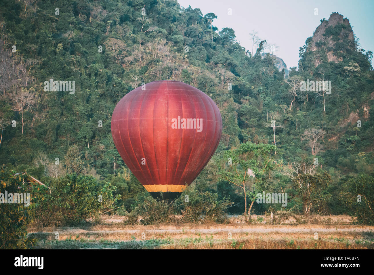 red hot-air balloon raising just in time to explore the beautiful ...