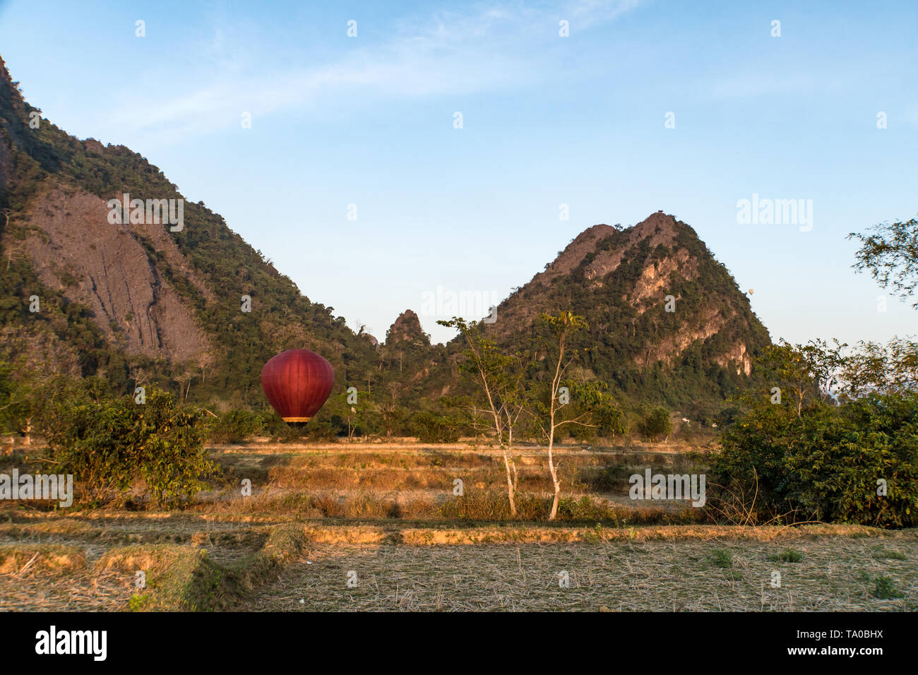 red hot-air balloon raising just in time to explore the beautiful ...