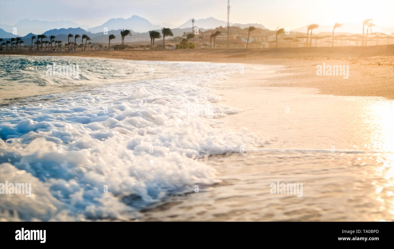 Closeup toned image of amazing susnet over the sandy sea beach and ...