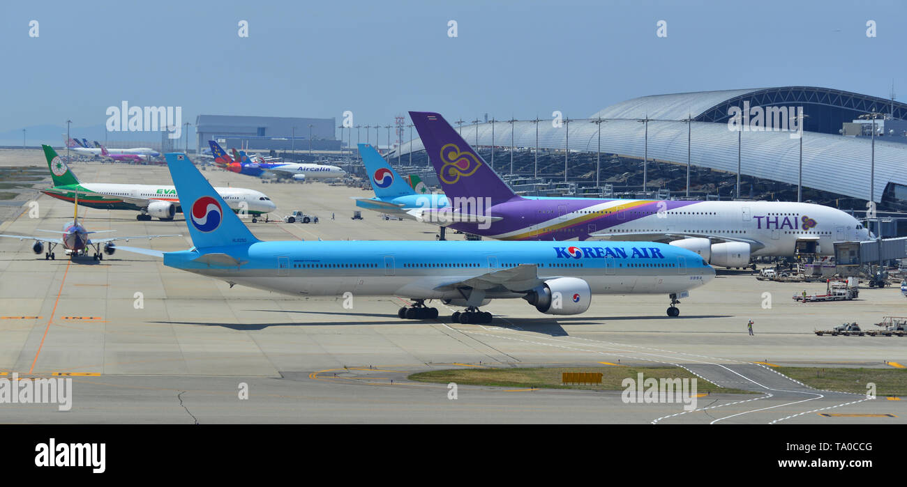 Osaka, Japan - Apr 18, 2019. Passenger airplanes taxiing on runway of ...
