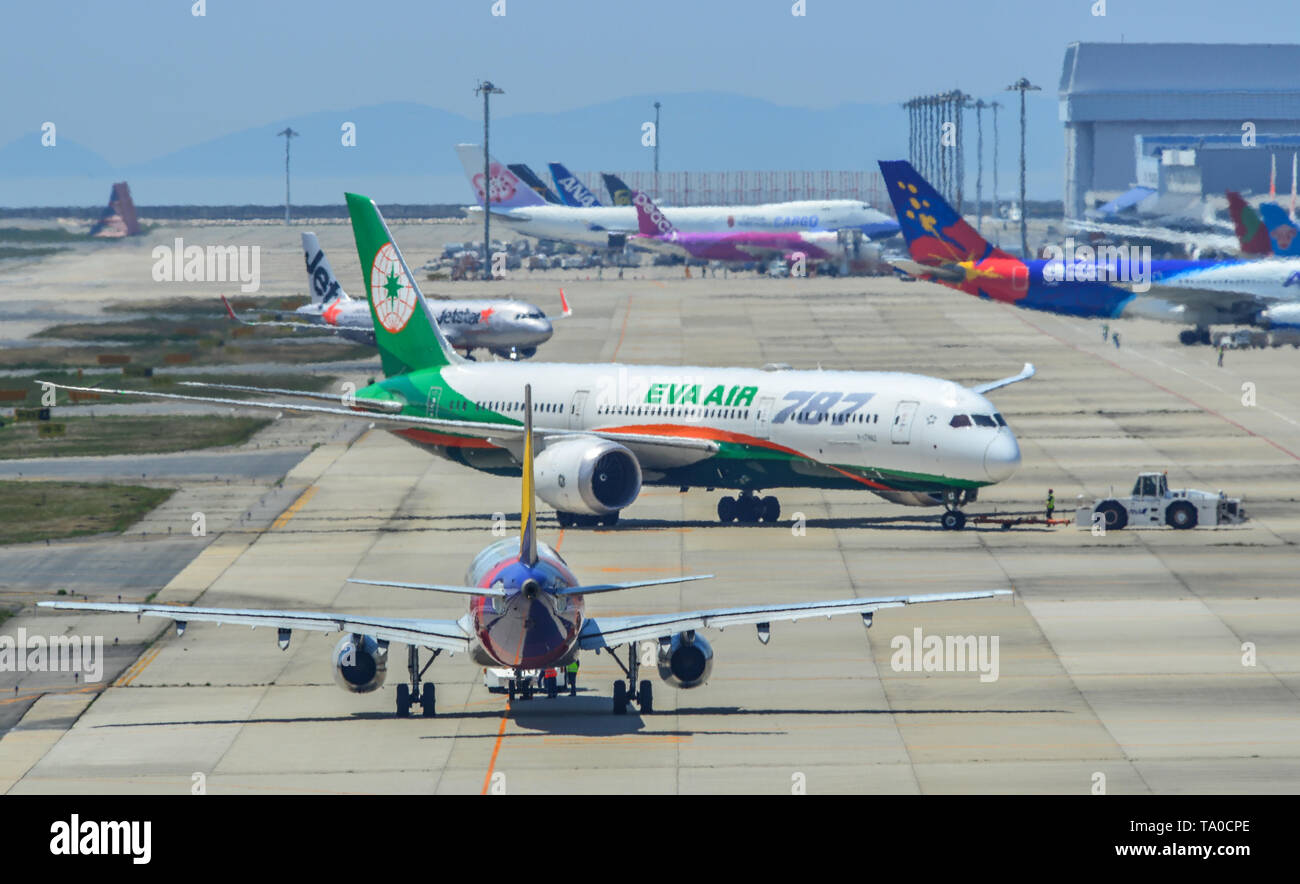 Osaka, Japan - Apr 18, 2019. Passenger airplanes taxiing on runway of ...