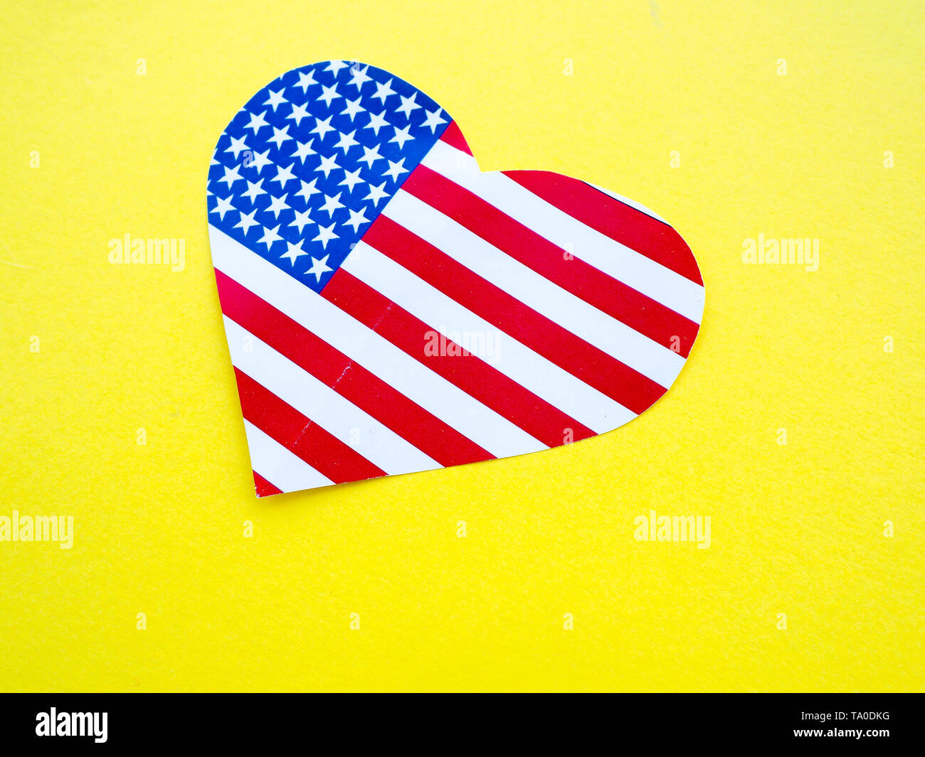 American flag in the shape of a heart on bright yellow background, USA ...