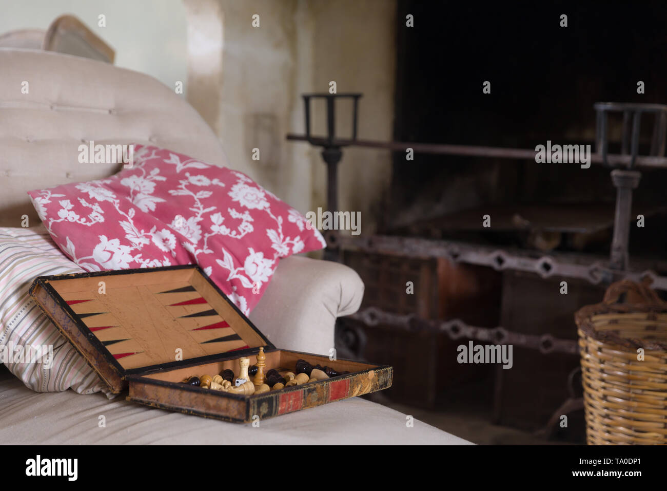 Still life interior with old fireplace and antique backgammon game ...