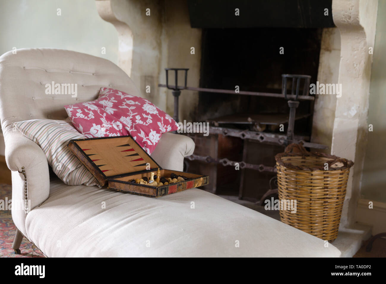 Still life interior with old fireplace and antique backgammon game ...