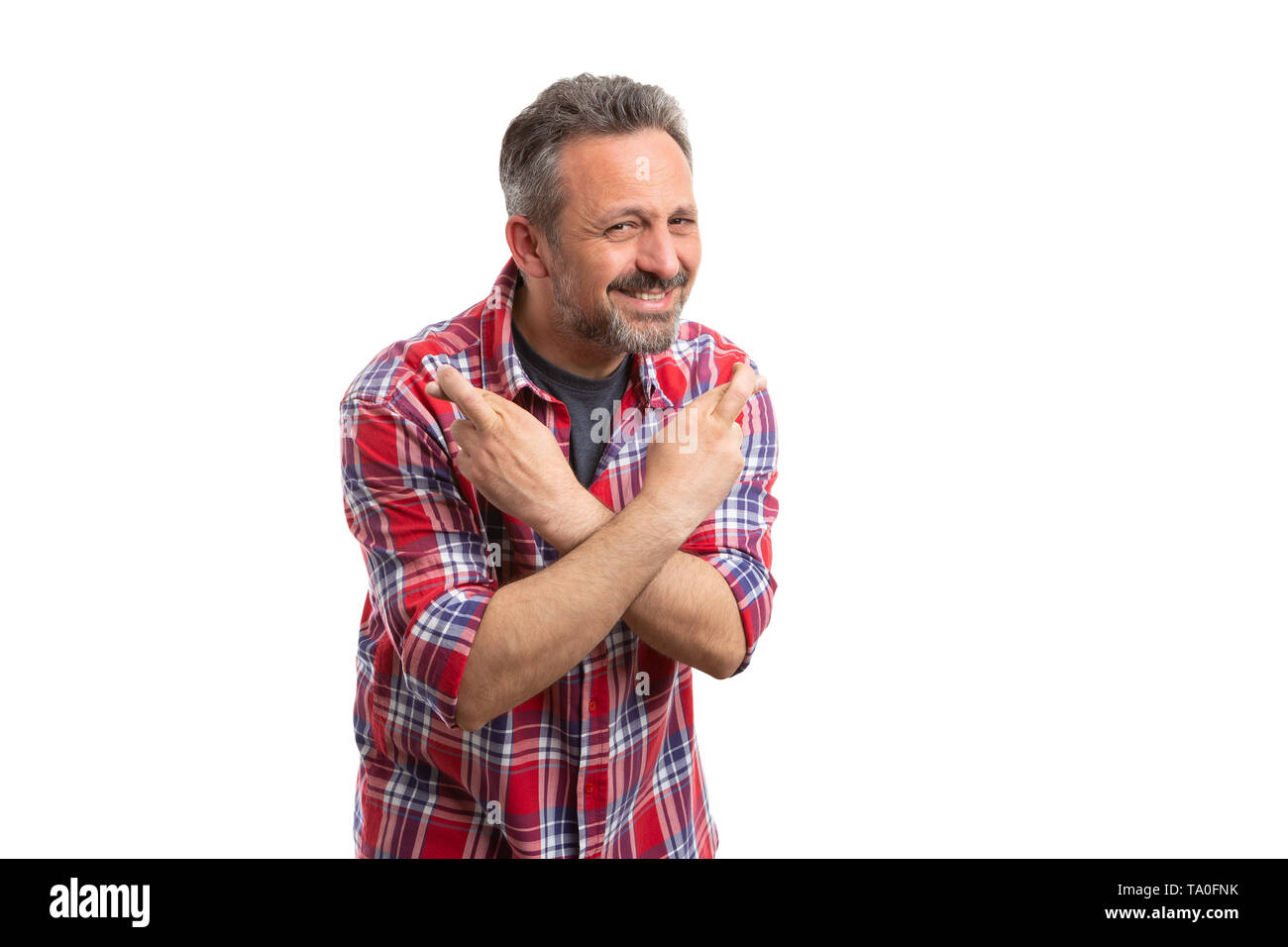 Cheerful man holding fingers crossed with smiling expression as good ...