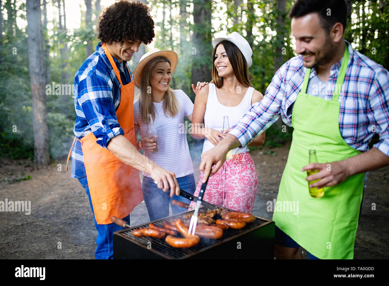 Group of friends having a barbecue party in nature Stock Photo - Alamy