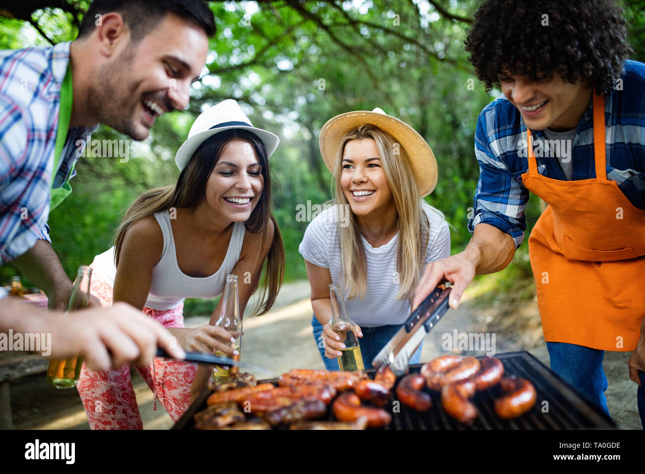 Group of happy friends having a barbecue party in nature Stock Photo ...
