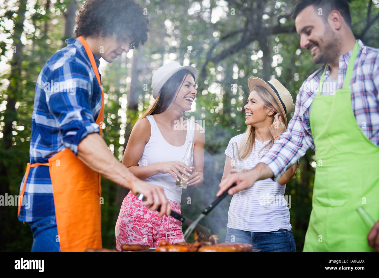 Group of friends having a barbecue party in nature Stock Photo - Alamy