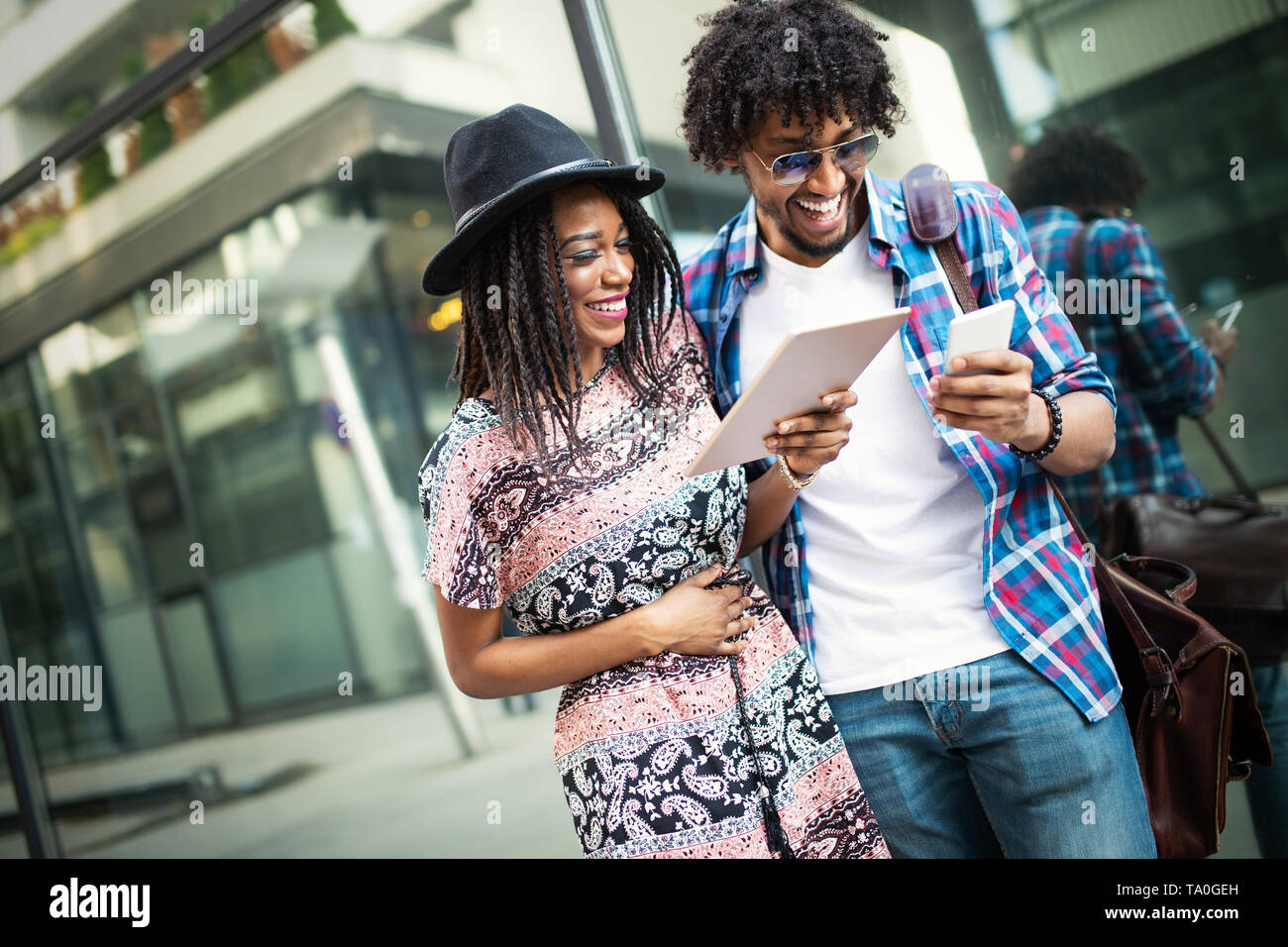 Attractive young african students are using a digital tablet and ...