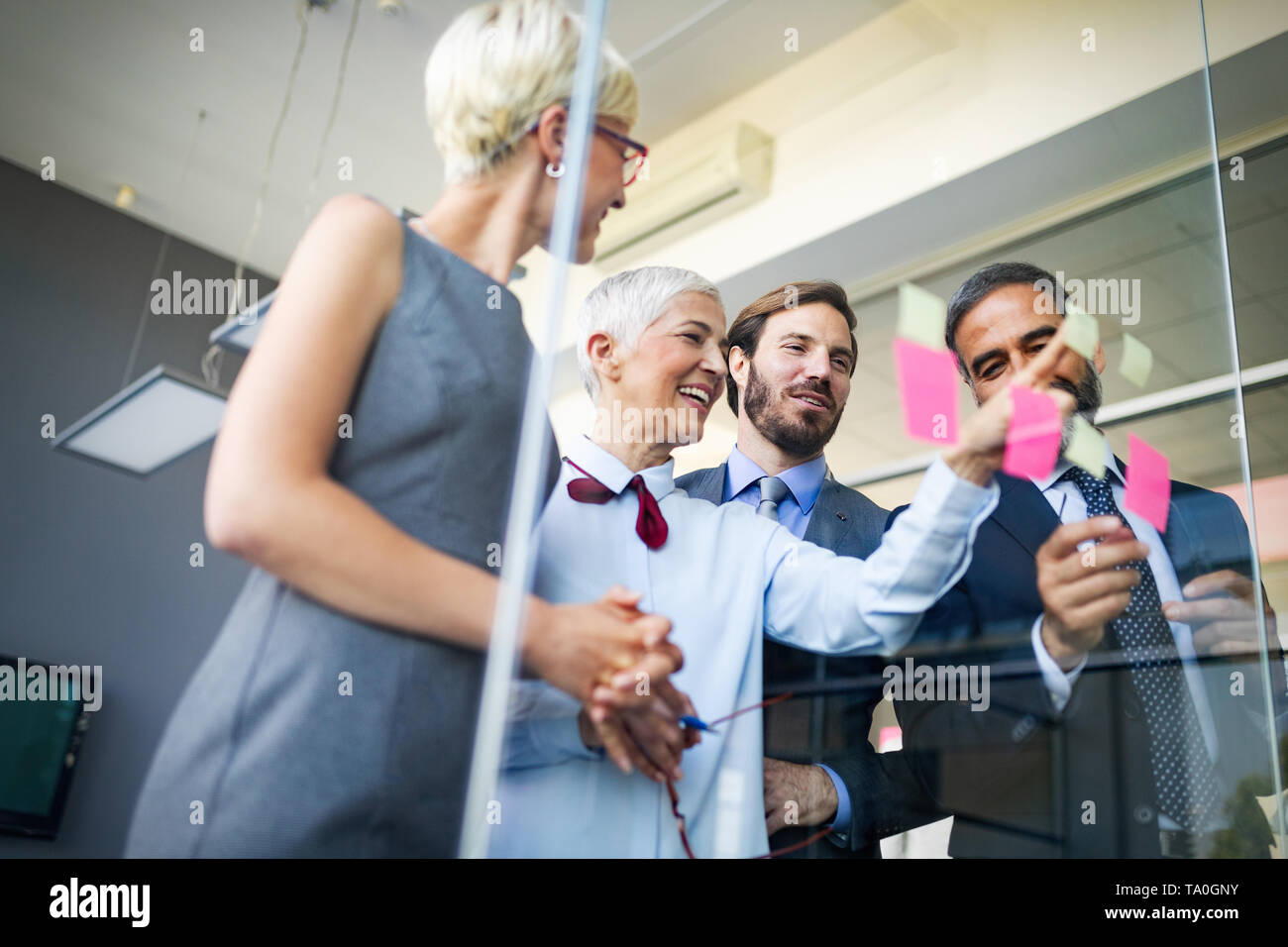 Successful company with happy workers in office Stock Photo - Alamy