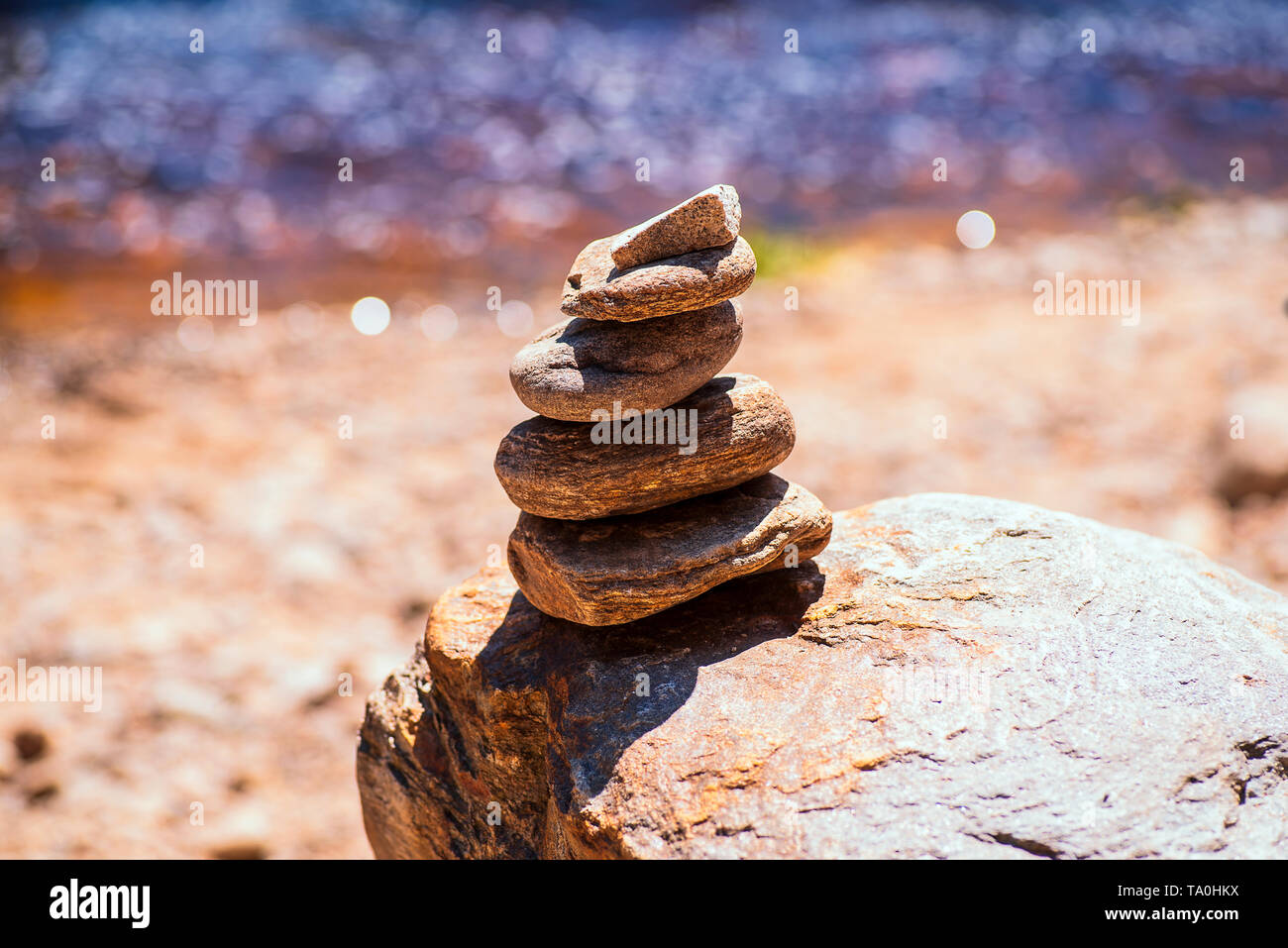 Stones pyramid on pebble beach symbolizing stability, zen, harmony ...