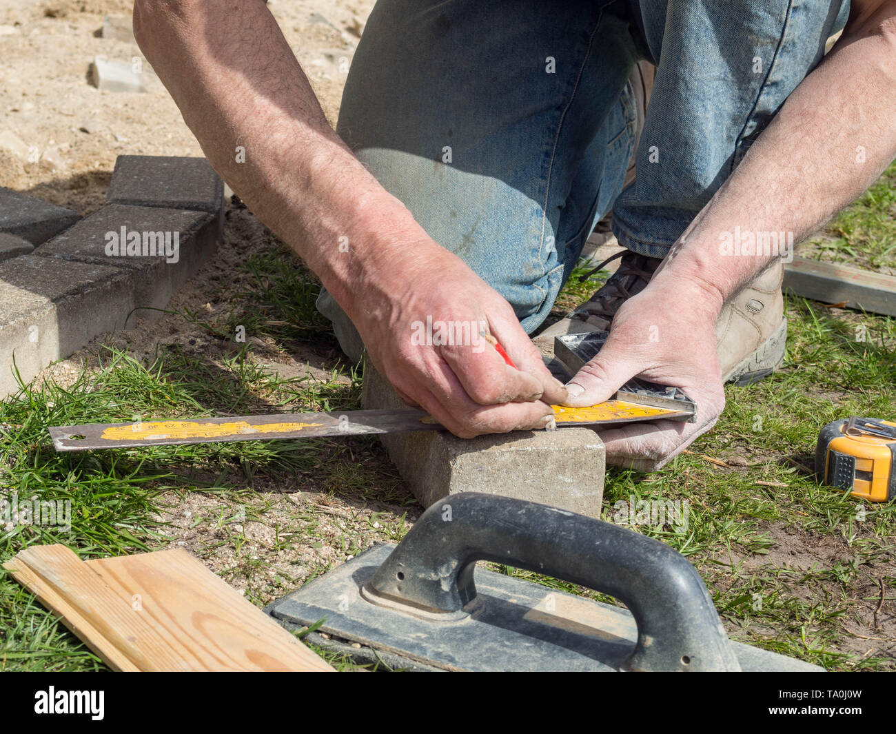 Builder measuring paving tiles stones close-up view from above Stock ...