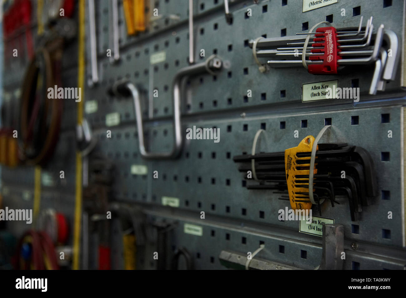 Workman DIY tools neatly displayed hanging on a wall in the garage ...