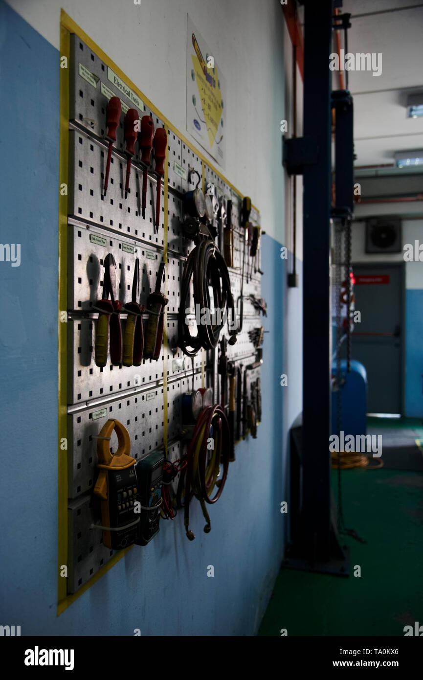 Workman DIY tools neatly displayed hanging on a wall in the garage ...