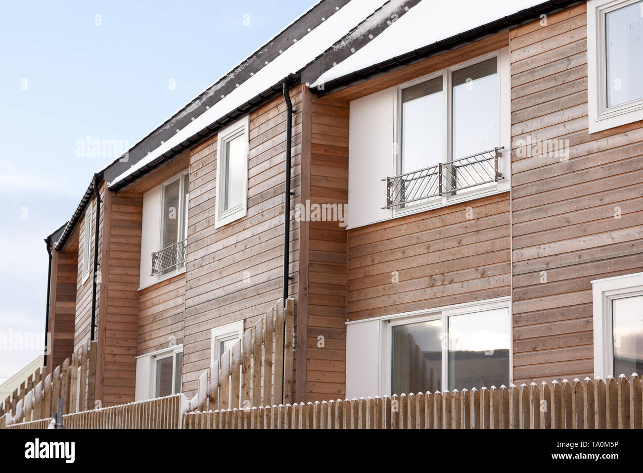 Group of wooden clad modern apartments or flats Stock Photo - Alamy