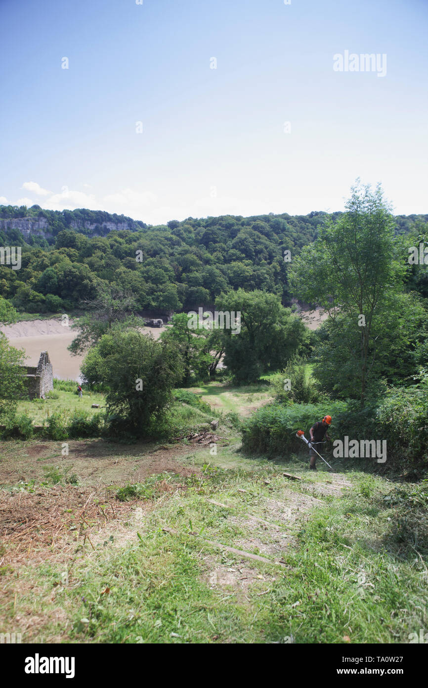 A workman strimming a footpath. Walking in the Wye Valley ...