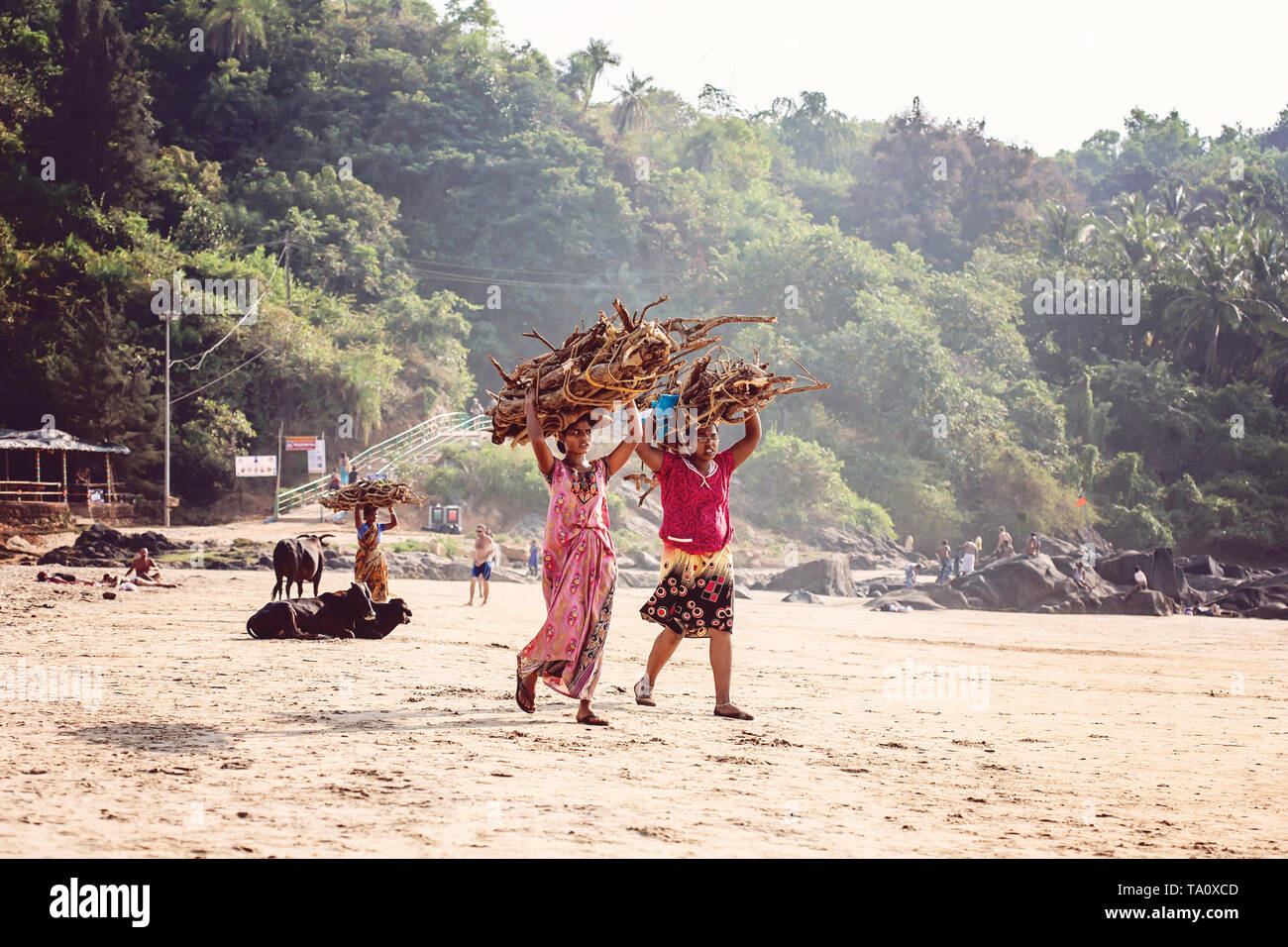 Kudli beach at Gokarna, India, January 15, 2018: Indian women walking ...