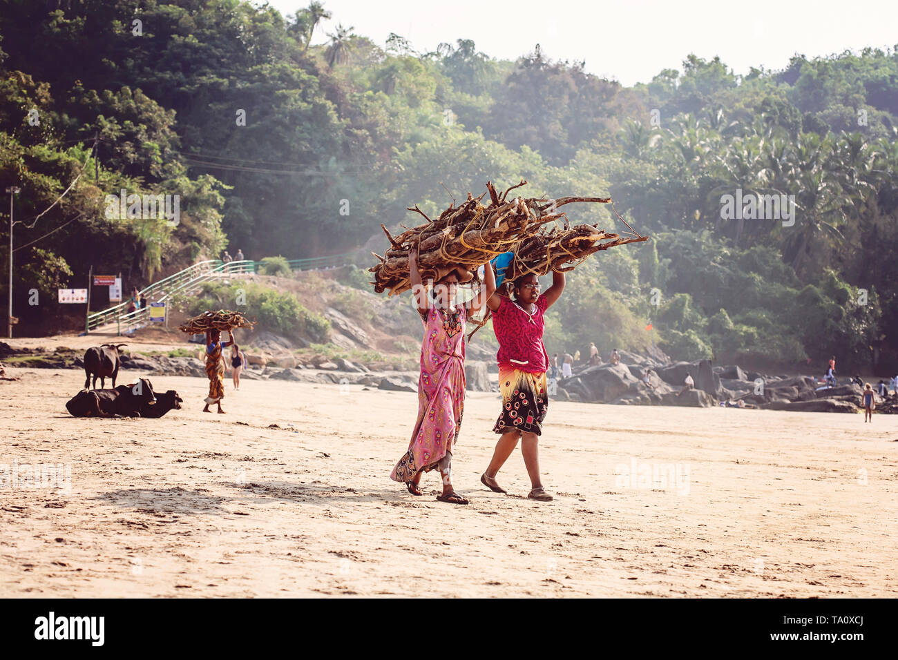 Kudli beach at Gokarna, India, January 15, 2018: Indian women walking ...