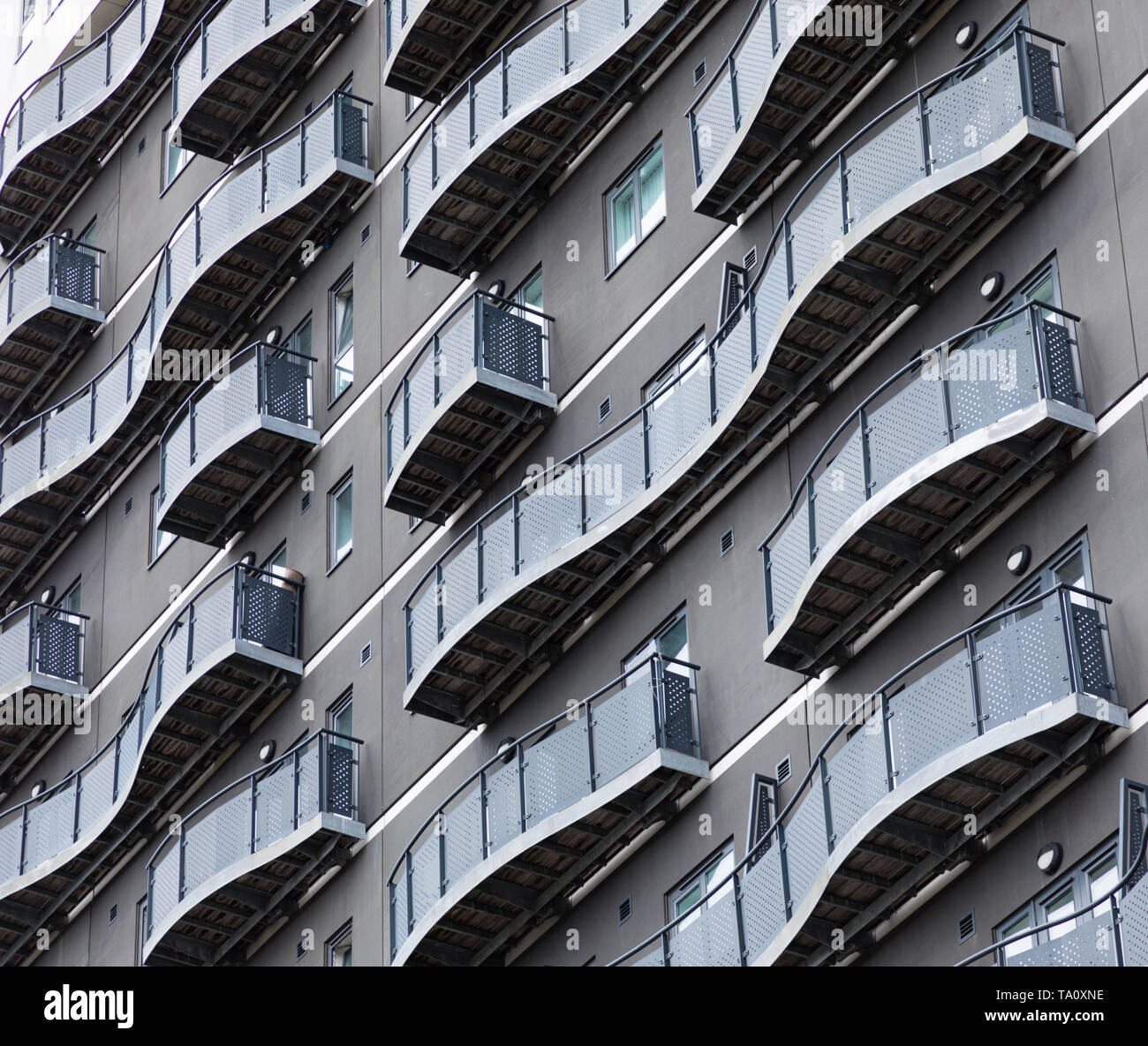 Looking up from street level at windows and curving, sinuous balconies ...