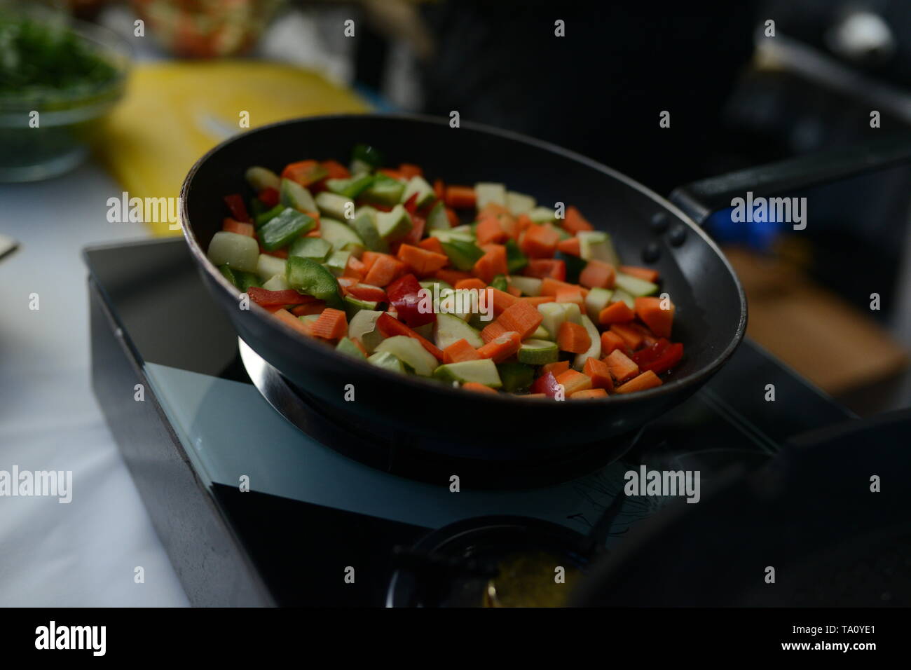 Making delicious food in restaurant. Professional cooker and vegetables ...