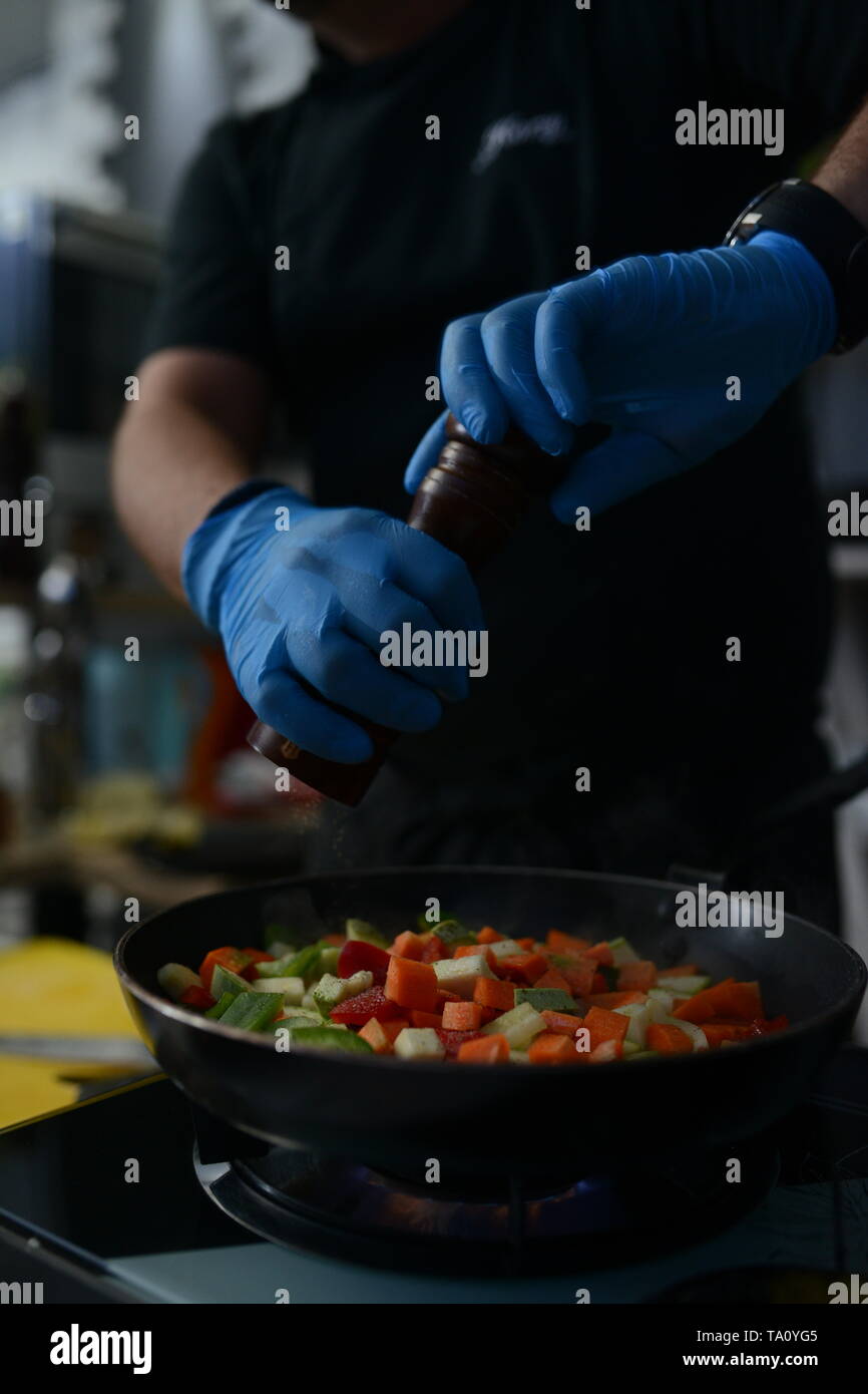 Making delicious food in restaurant. Professional cooker and vegetables ...