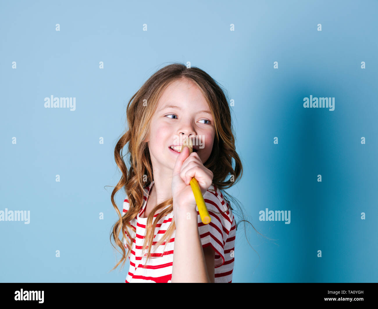 pretty cool and young girl uses cooking spoon as microphone and sings ...