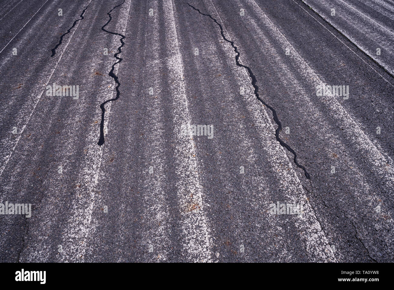 faded white road markings on a street for backgrounds Stock Photo - Alamy