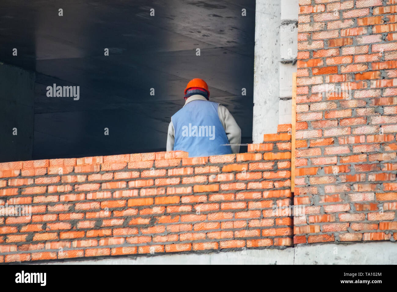 Worker making brick wall at a new building construction site Stock ...