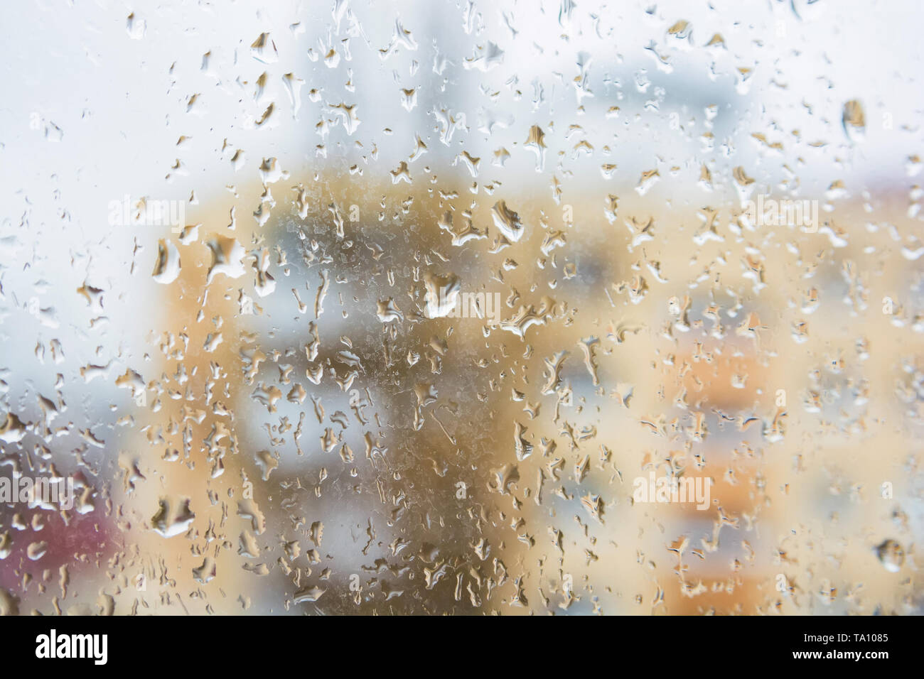 Rain drops on window glasses surface with with modern appartment ...