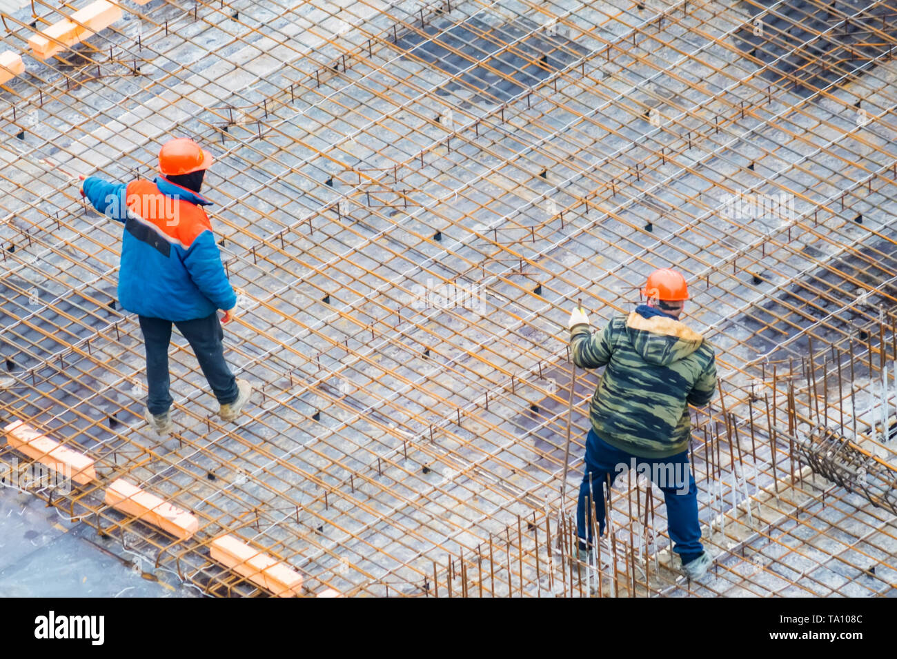 Workers and carcass made of fitness at construction site Stock Photo ...