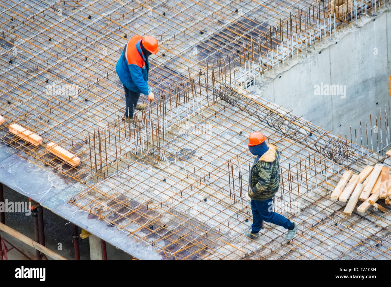 Workers and carcass made of fitness at construction site Stock Photo ...
