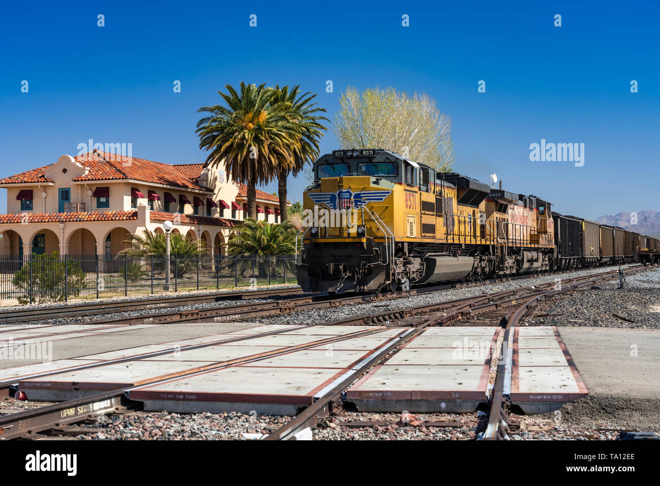 A freight train at a crossing in the Mojave Desert, California, USA ...
