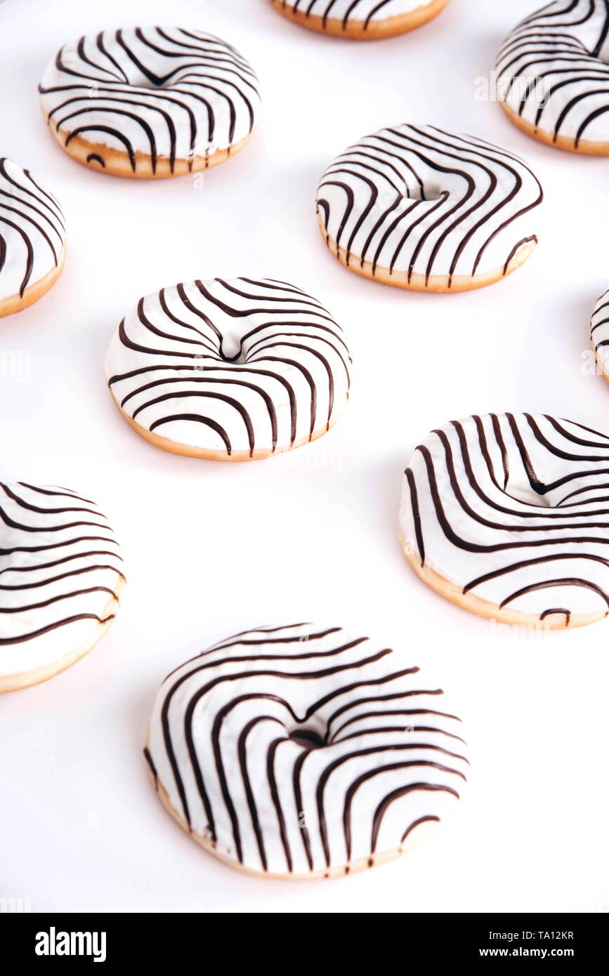 Striped donuts on a white background Stock Photo - Alamy