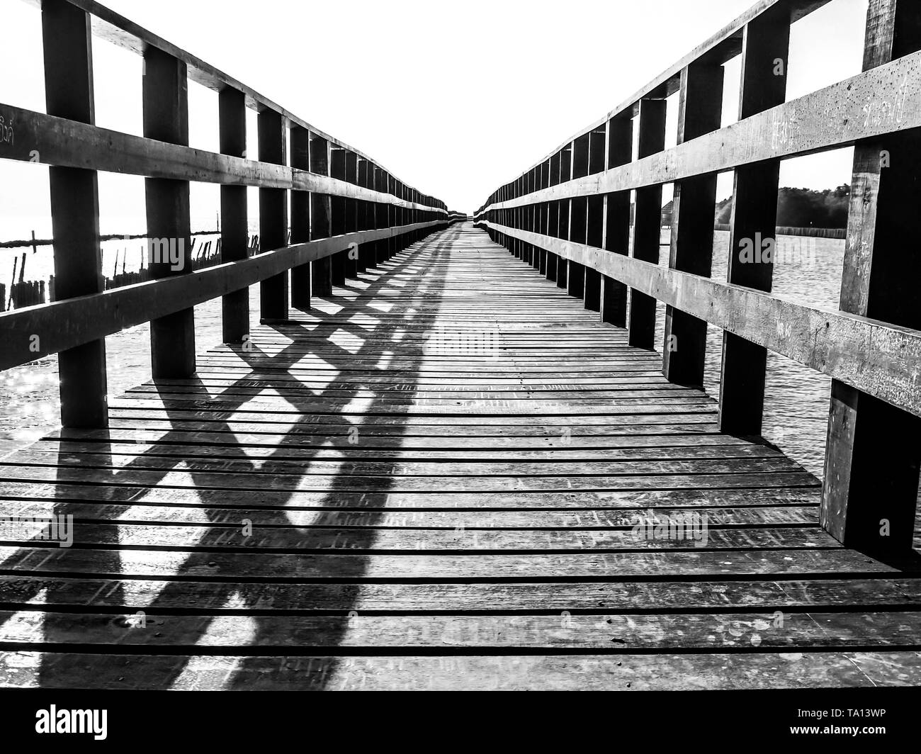 old wooden rustic bridge at sea, natural balck and white background ...