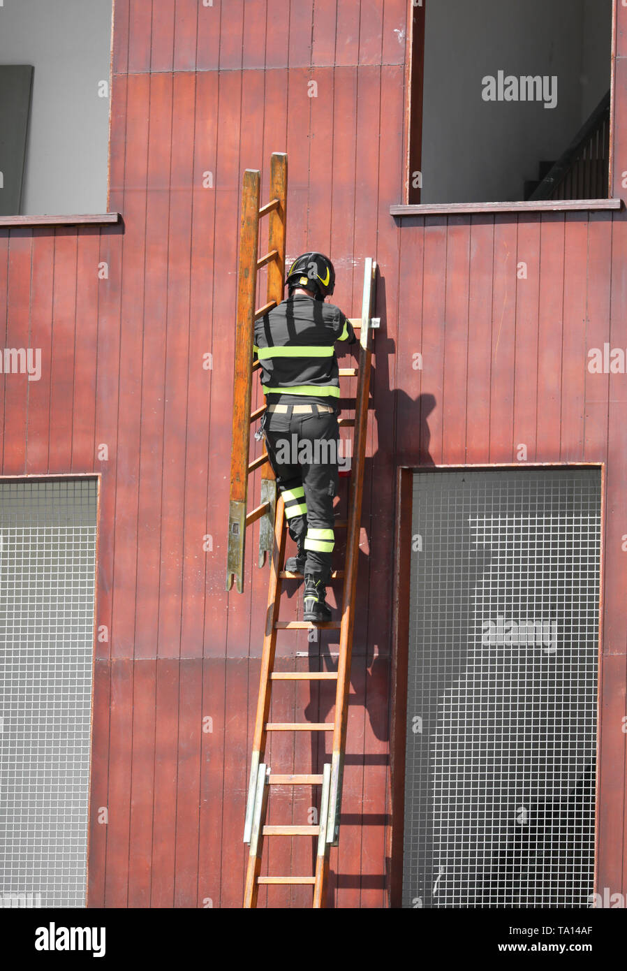 rescue exercises with the ladder and fireman with helmet in the fire ...