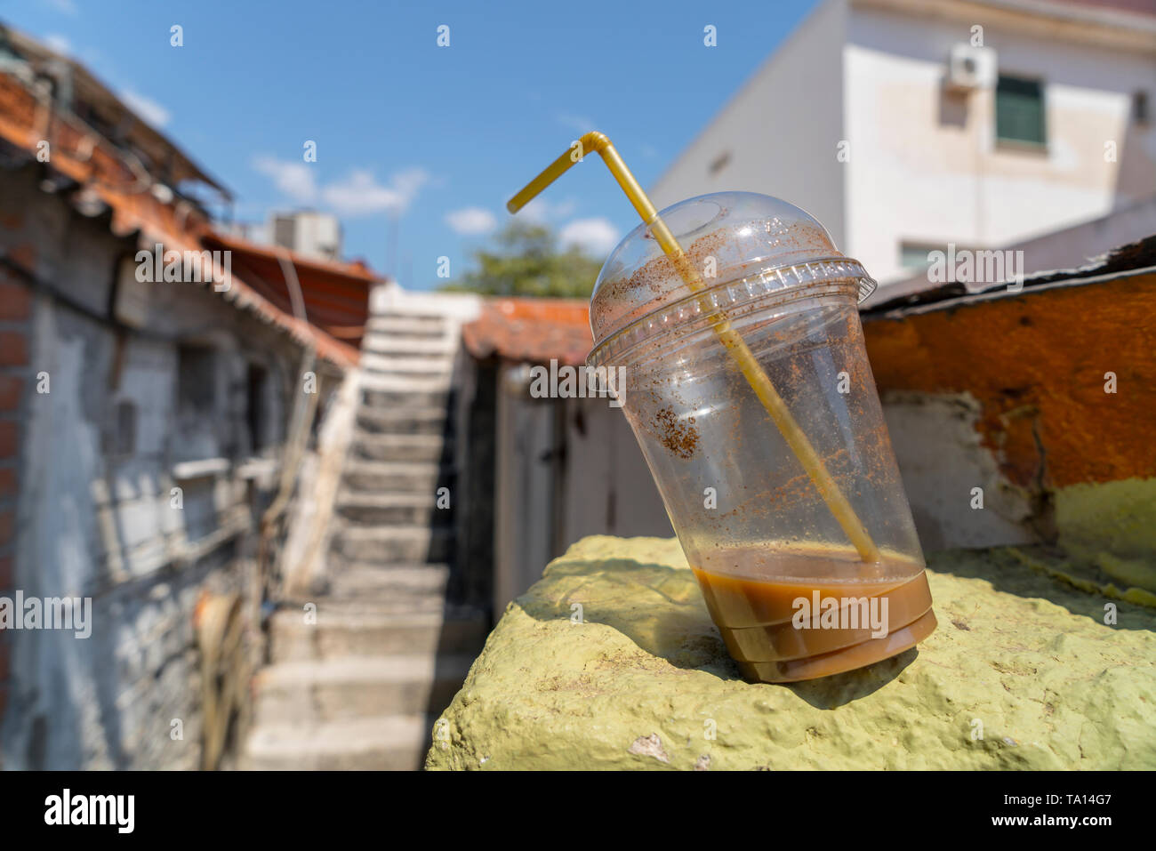 abandoned old plastic drinking cup with coffee Stock Photo - Alamy