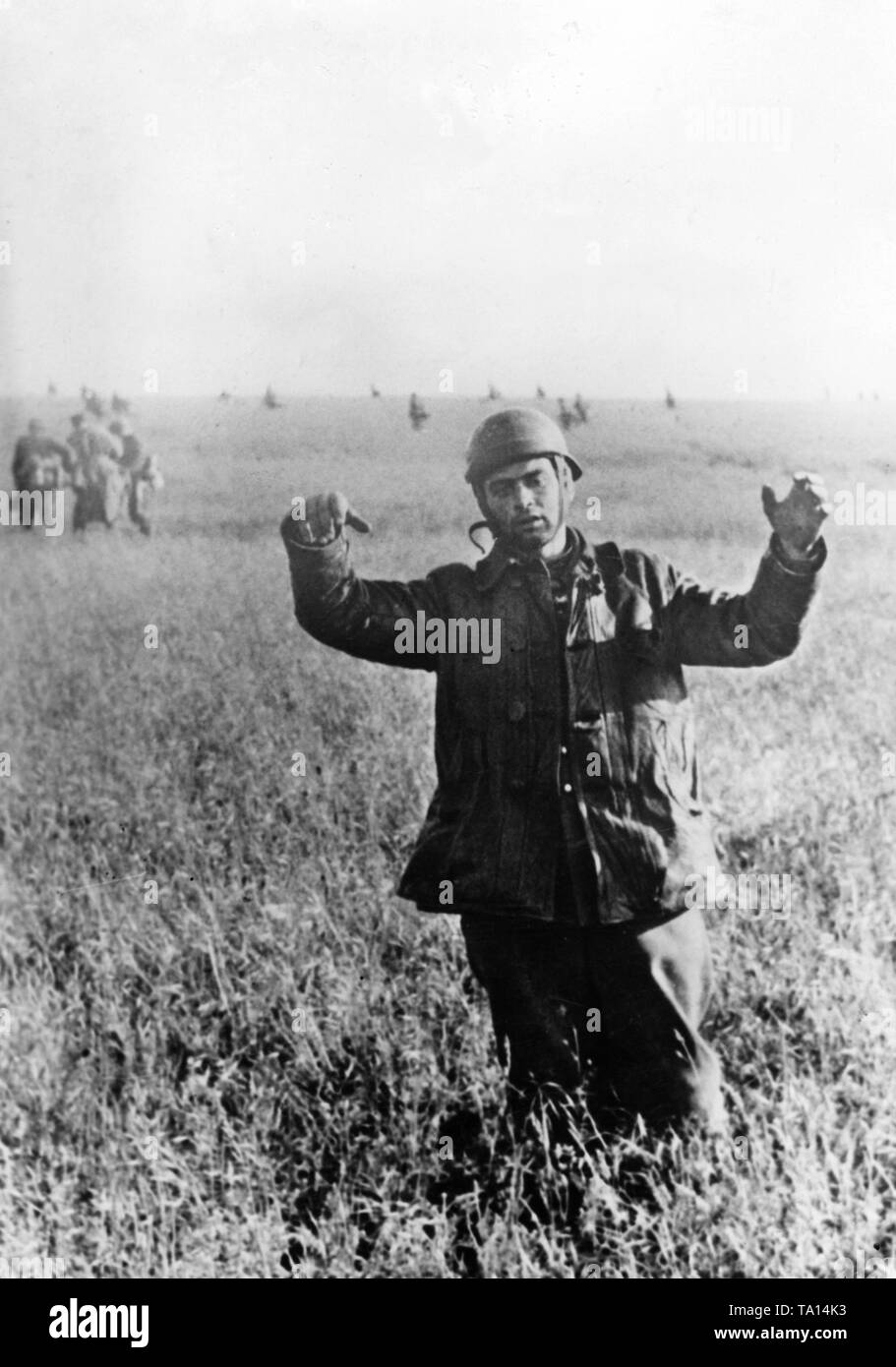A soldier surrenders to German troops. Photo: Kaufmann Stock Photo - Alamy