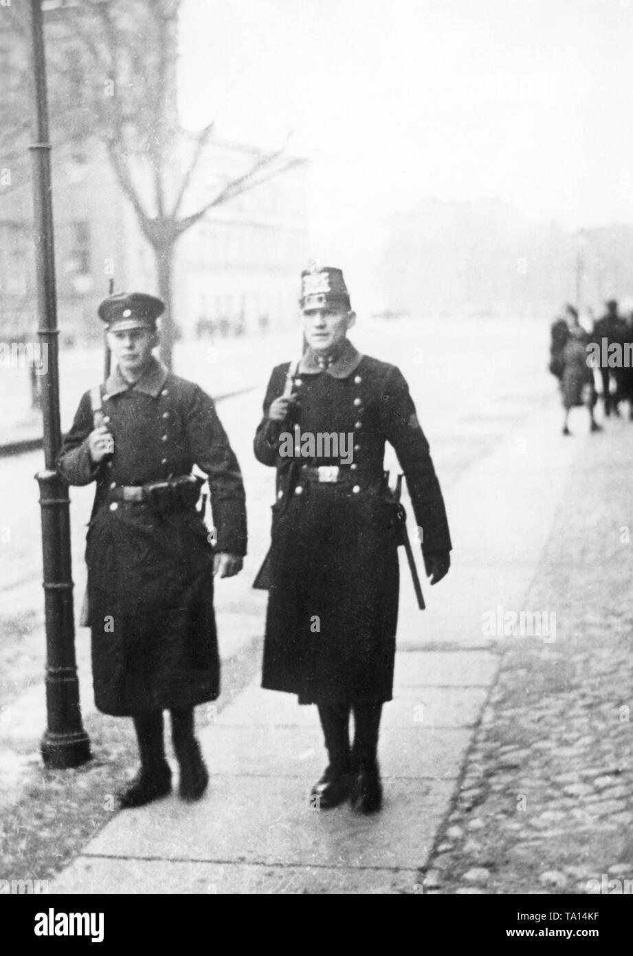 A policeman (left) is supported on his patrol by a member of the ...