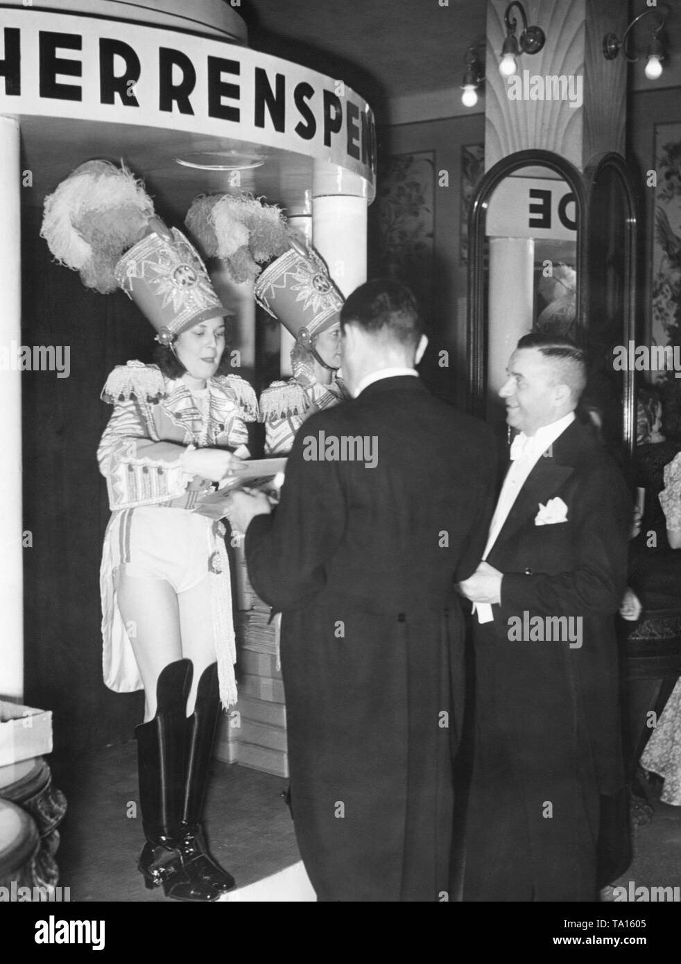 Young women in costumes distribute gifts to men, from the movie "The ...
