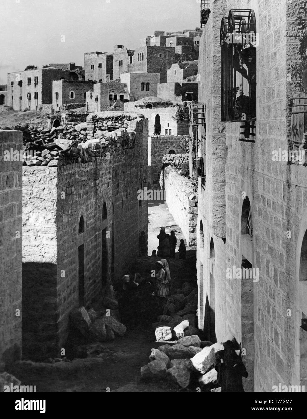 People looking for a shade on a street in the old town of Bethlehem in ...