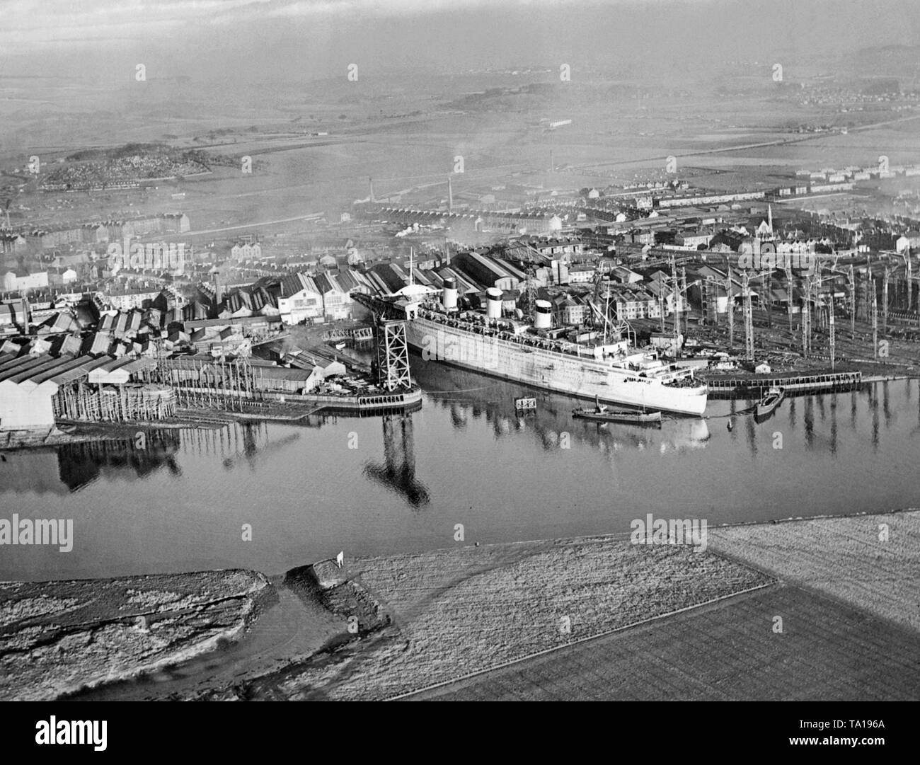 The "Queen Mary" lies in the fitting-out quay of the shipyard John ...