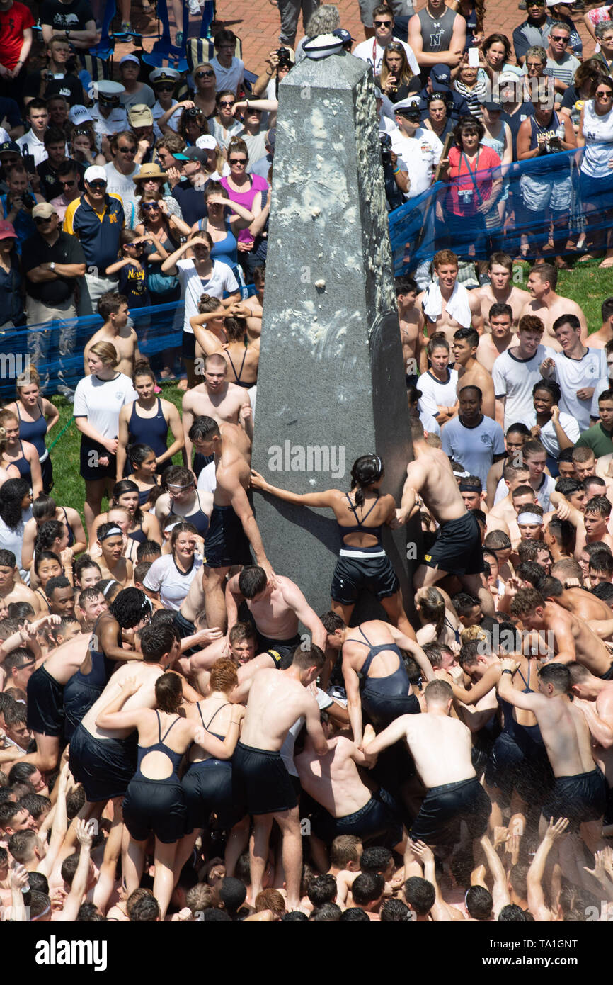 U.S Naval Academy plebes form a human pyramid as they attempt to climb ...