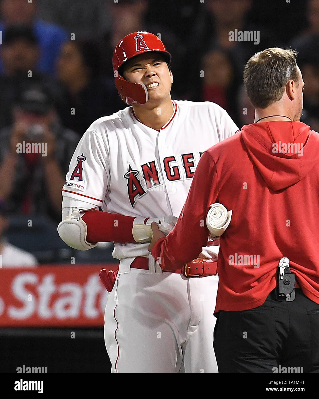 Los Angeles Angels designated hitter Shohei Ohtani winces in pain as he ...