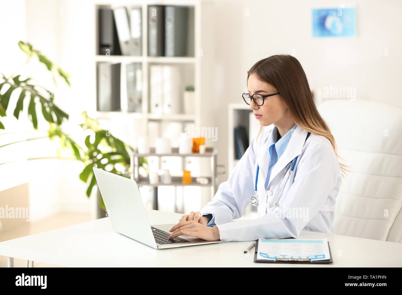 Doctor working on laptop in hi-res stock photography and images - Alamy