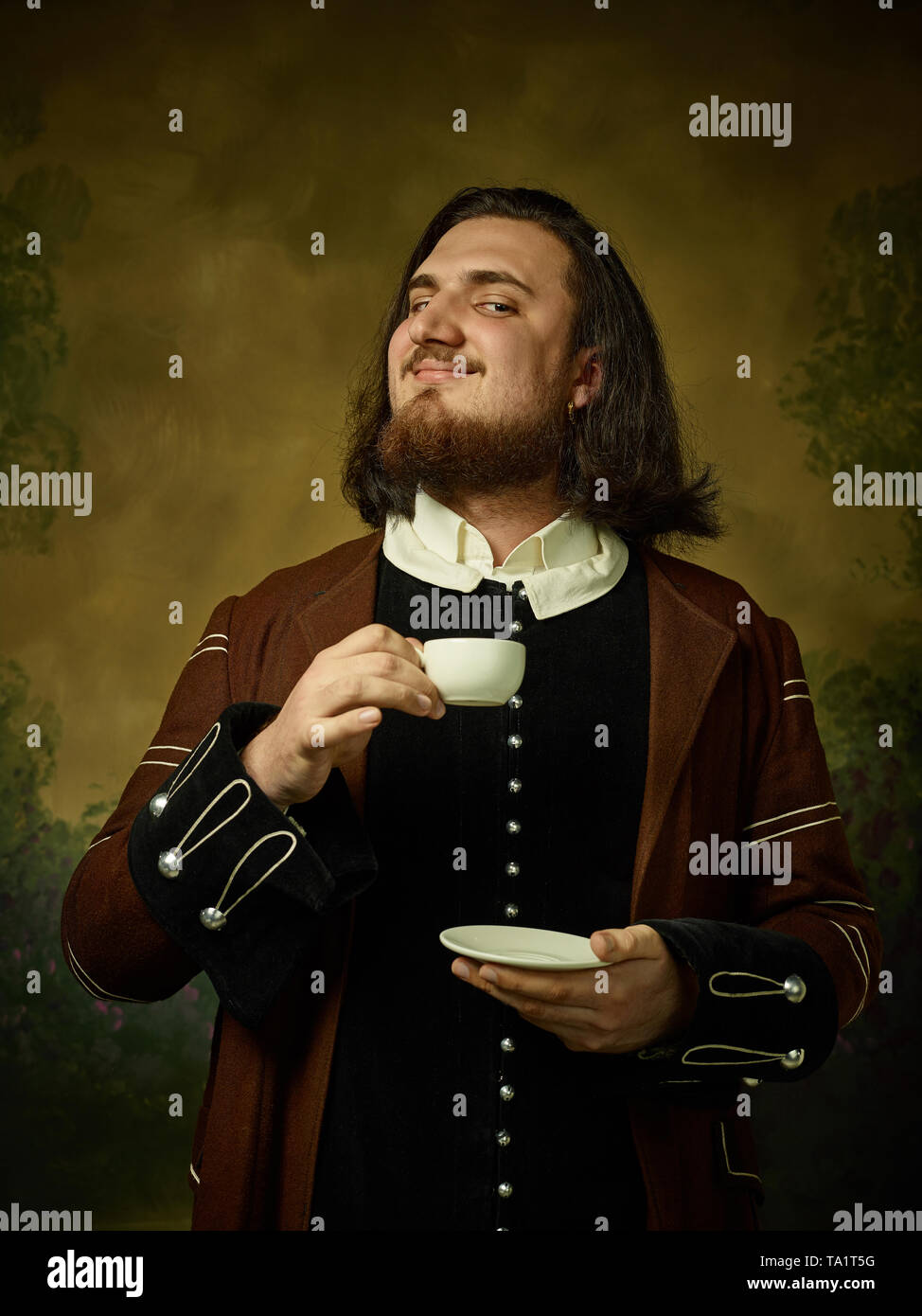 Young man as a medieval knight on dark studio background. Portrait in ...