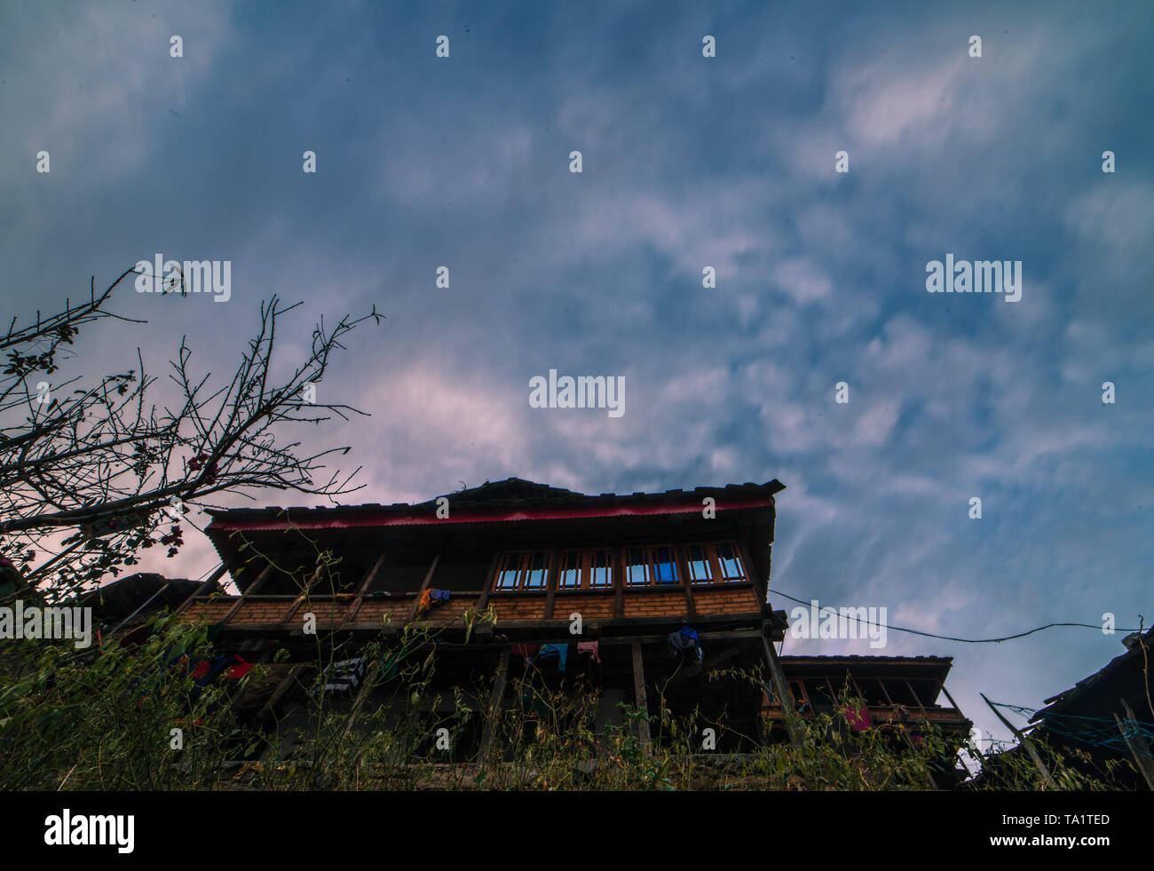 Sunset over traditional wooden house, Amazing scene with Himalayan ...