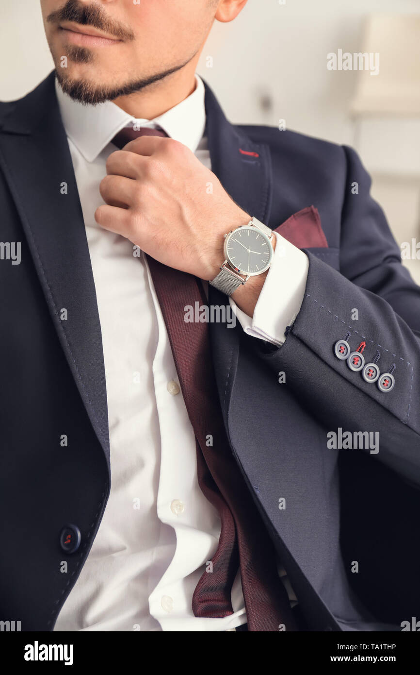 Businessman adjusting watch hi-res stock photography and images - Alamy