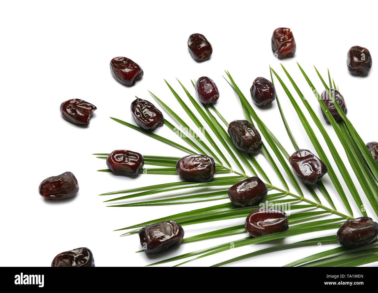 Sweet dried dates and palm leaf on white background Stock Photo - Alamy