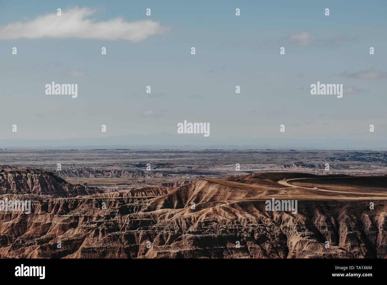 Cars drive on a scenic road in Badlands National Park, South Dakota ...